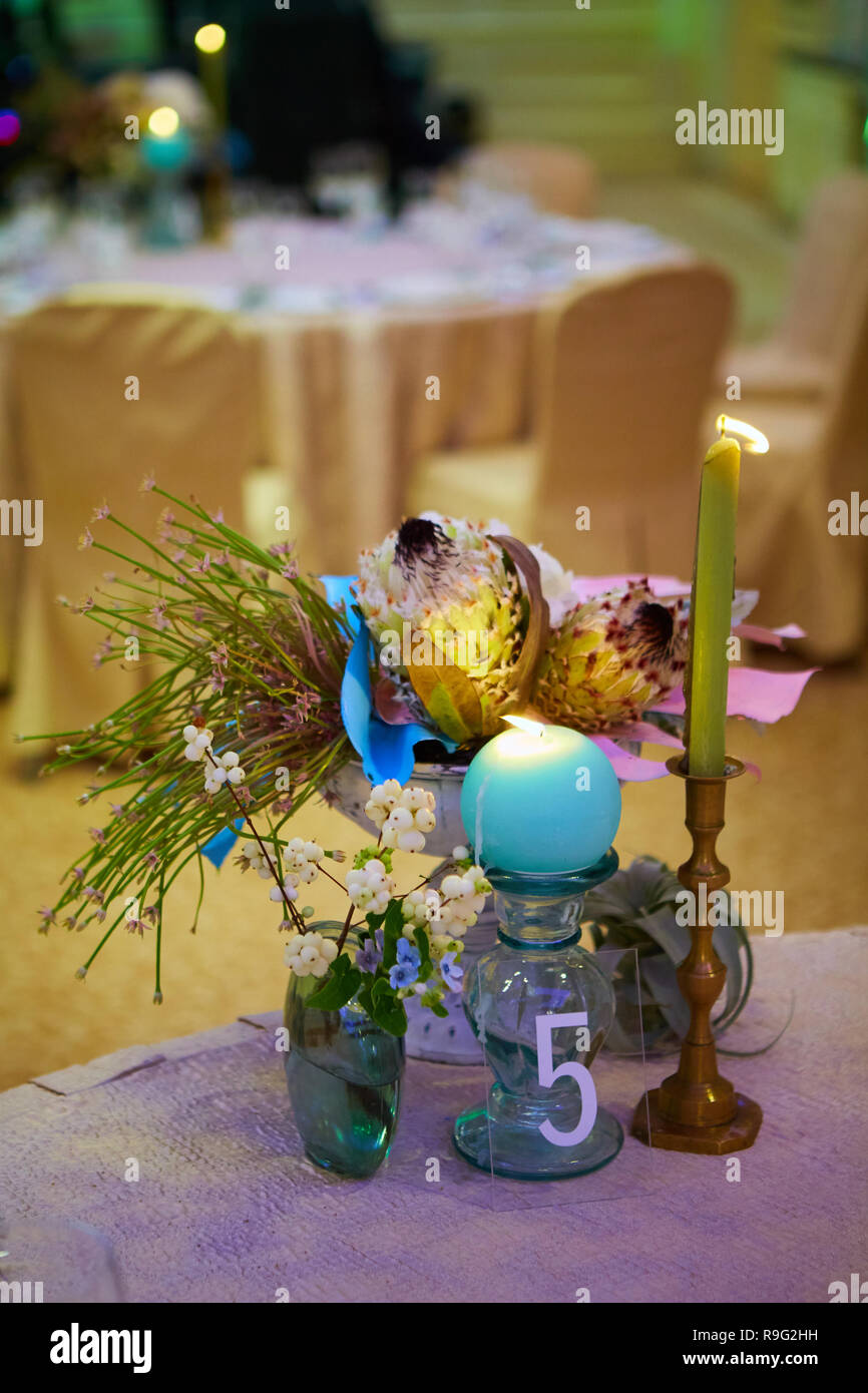 Elegant wedding guest table set for an event with candles lit Stock ...