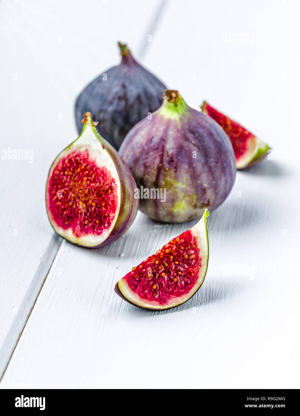 Fresh figs, cut and whole on white background Stock Photo - Alamy