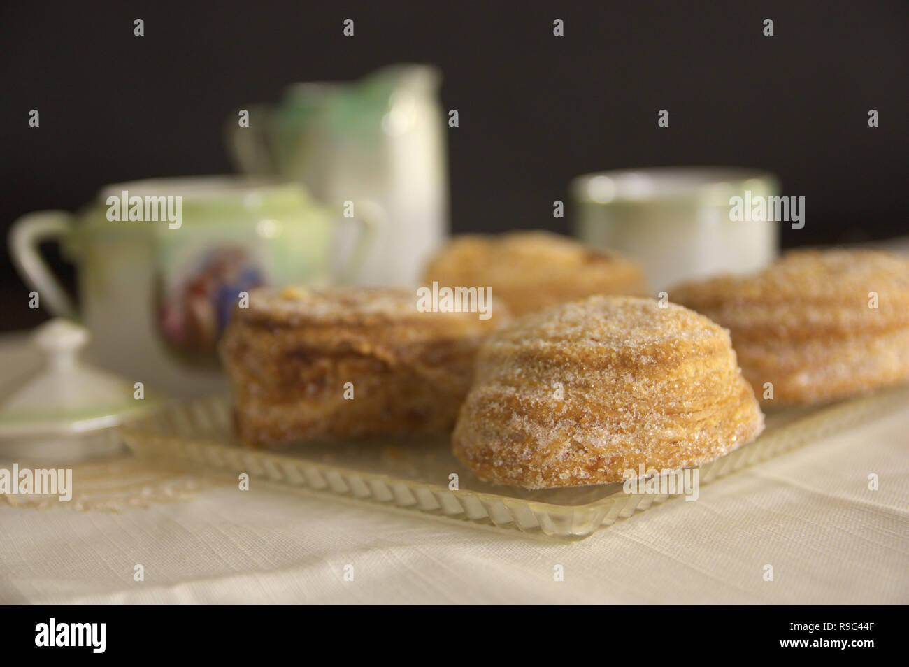 English-style snack with cups of hot drinks and flaky sweets Stock ...