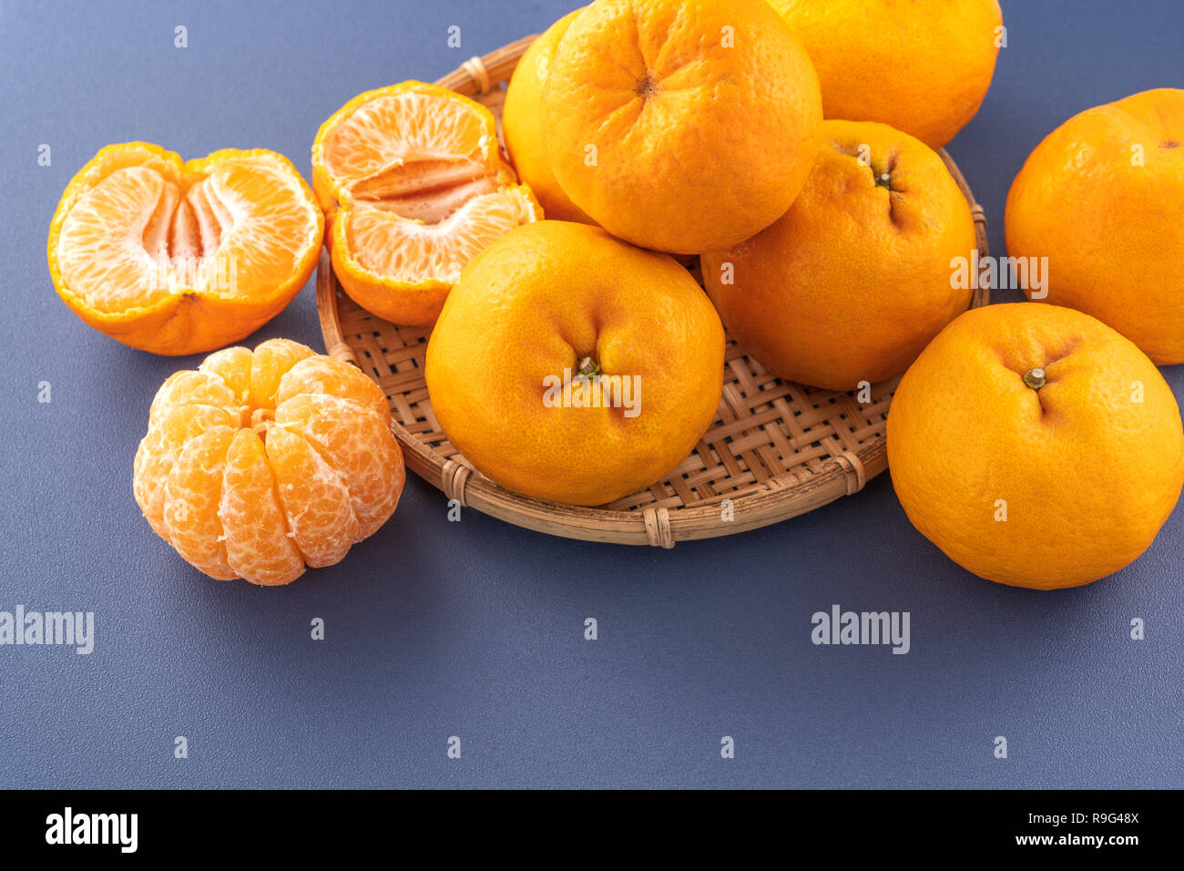 Beautiful and delicous tangerine isolated on airy blue background with ...