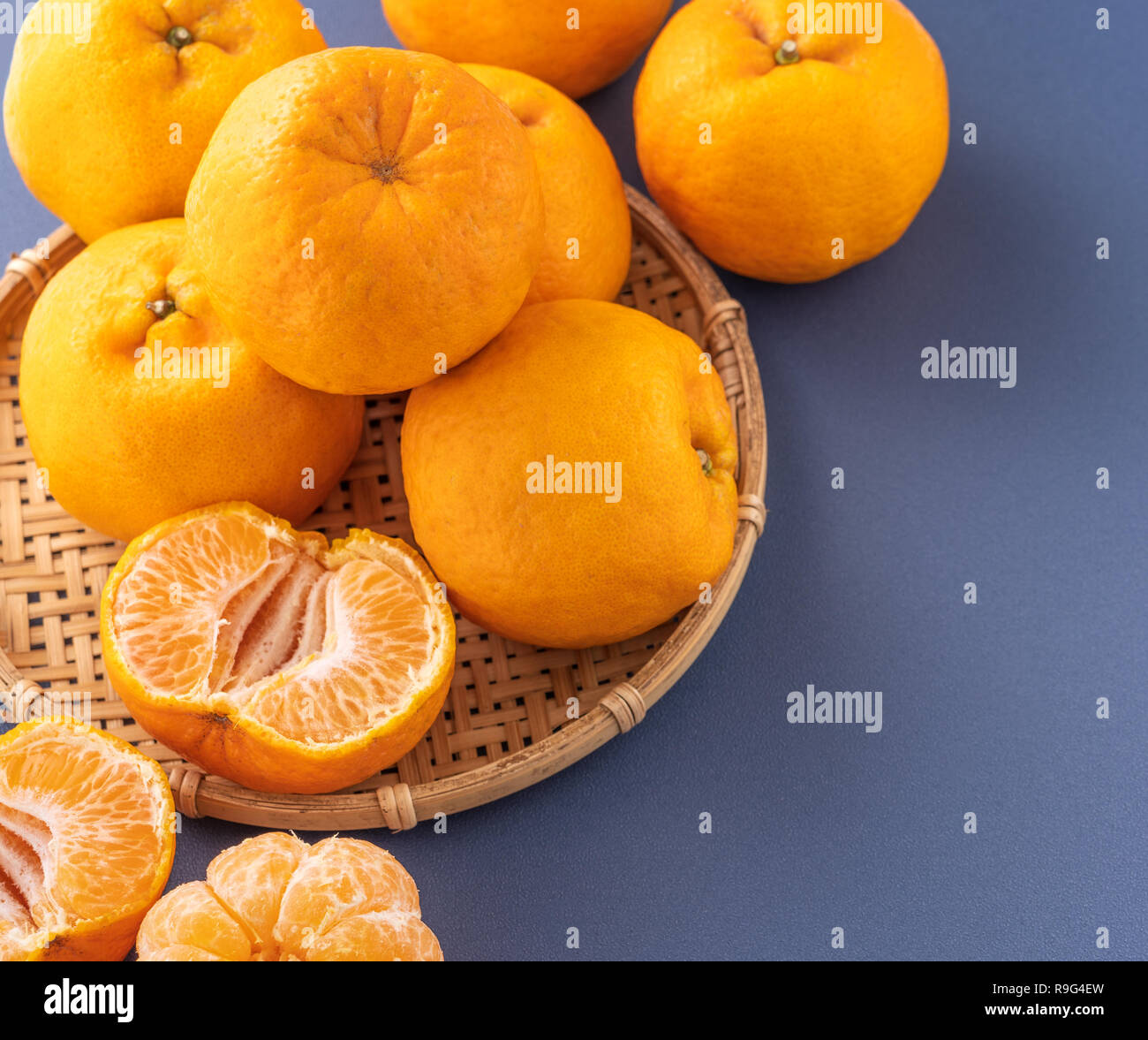 Beautiful and delicous tangerine isolated on airy blue background with ...