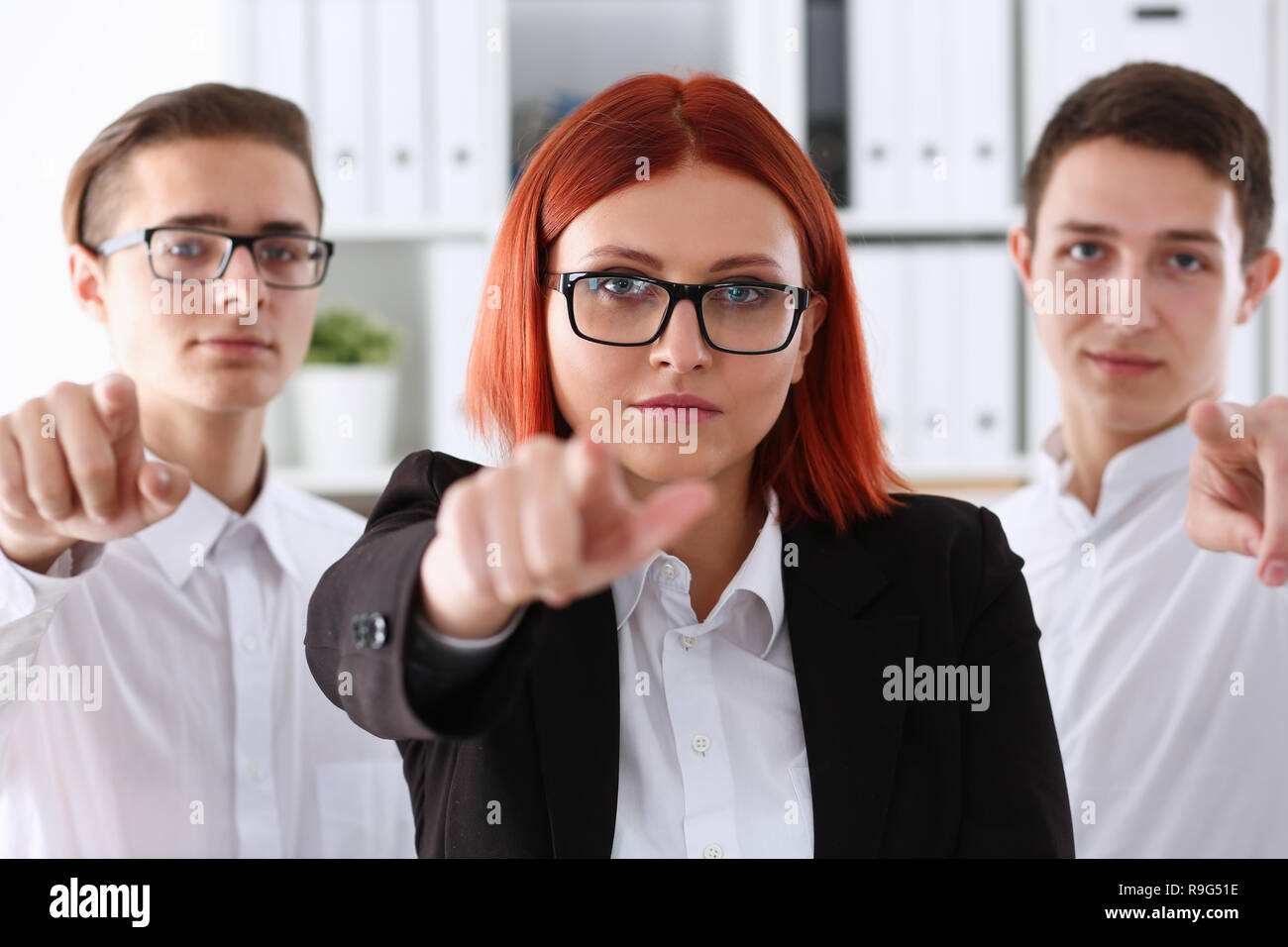A group of business people pointing their Stock Photo - Alamy