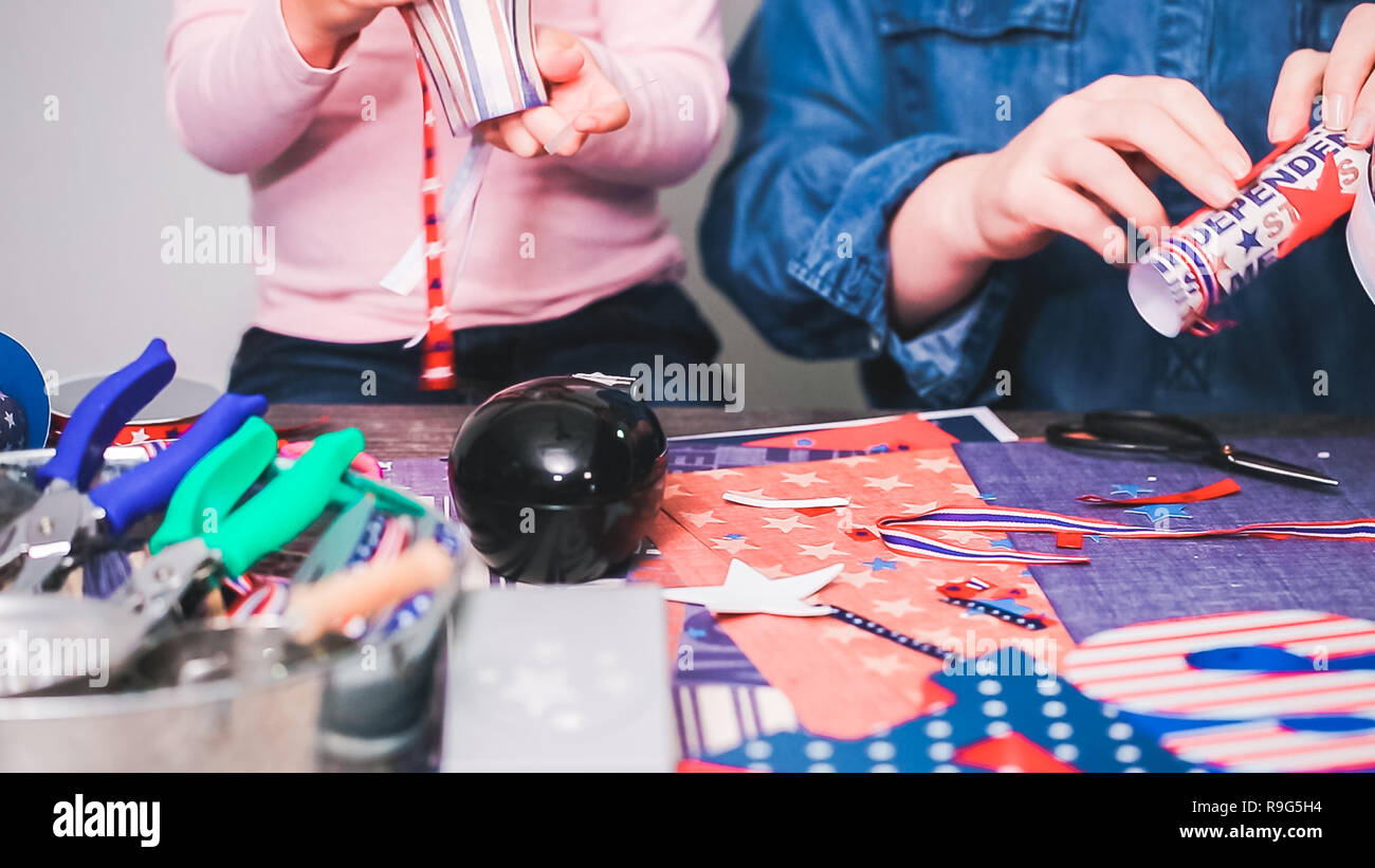 Step by step. Mother and daughter making paper firecrackers for July ...