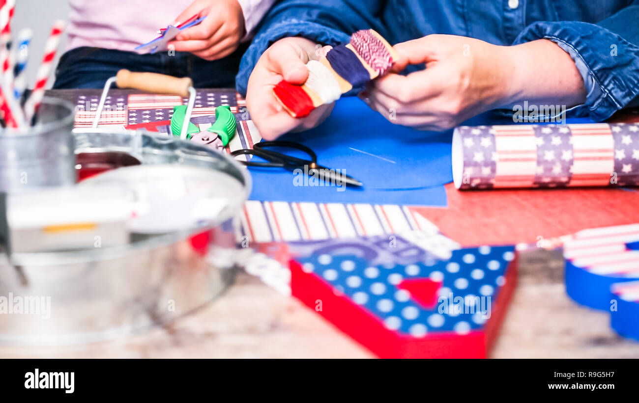 Step by step. Mother and daughter making paper firecrackers for July ...