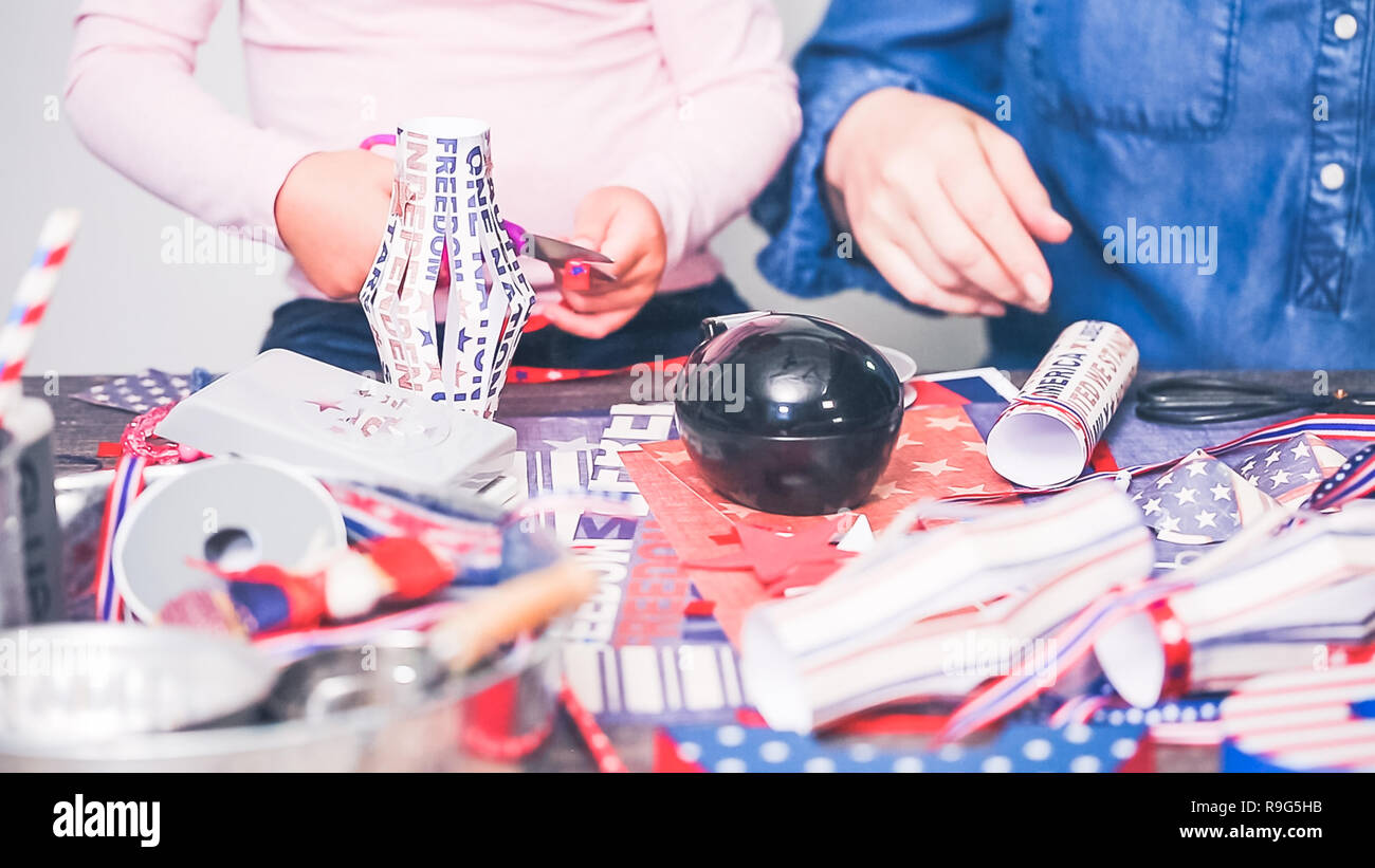 Step by step. Mother and daughter making paper firecrackers for July ...