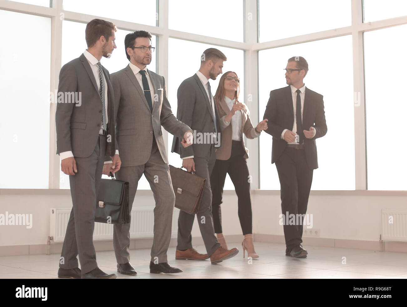 Businesspeople walking in the office background Stock Photo - Alamy