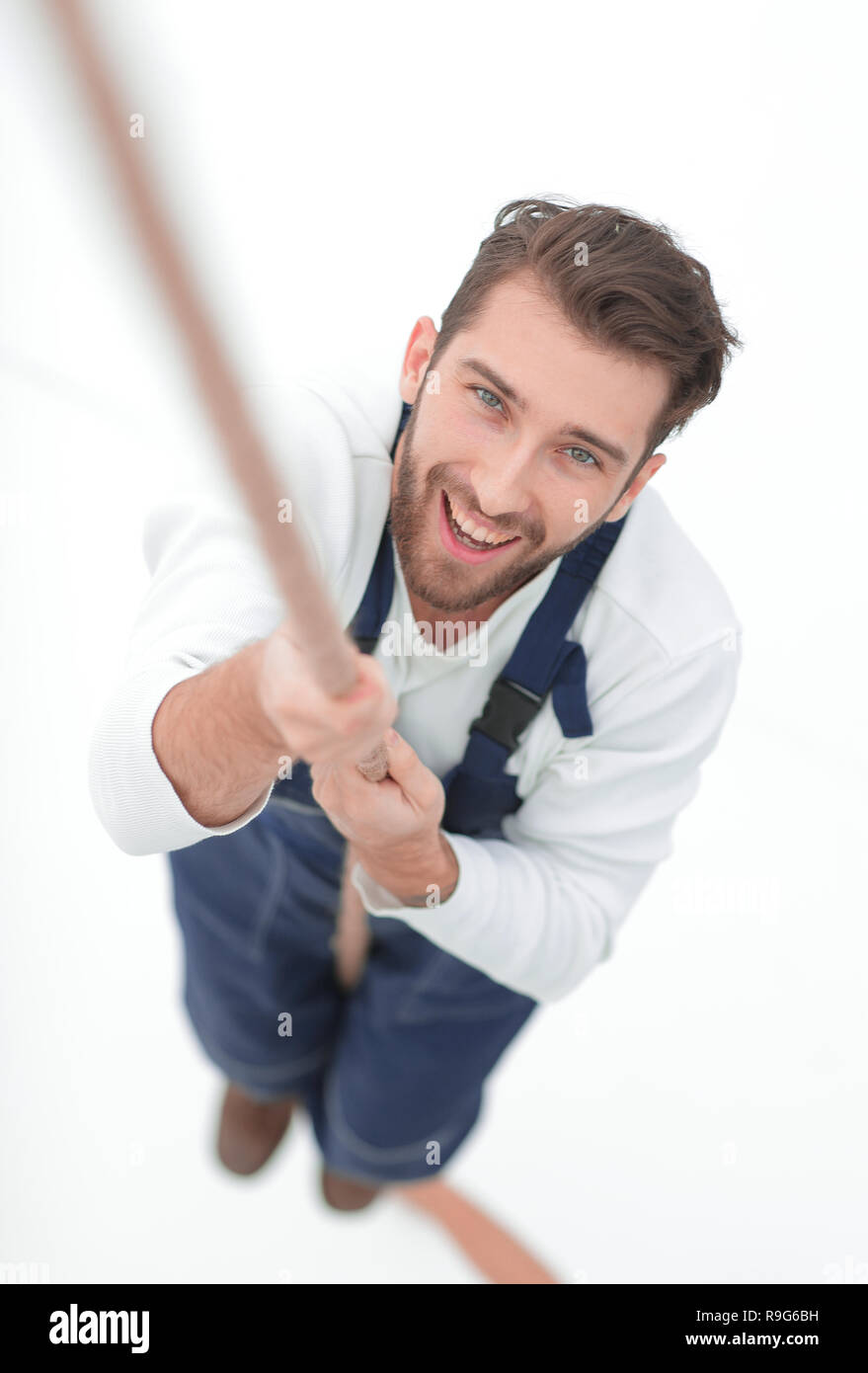 construction worker climbing the rope up Stock Photo - Alamy