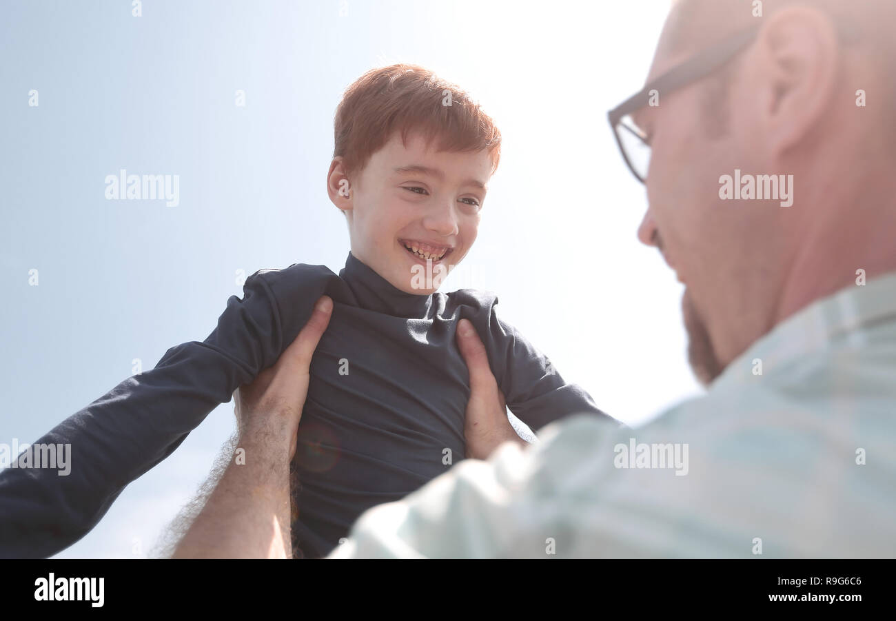 stylized photo.a happy son in his father's safe hands Stock Photo - Alamy