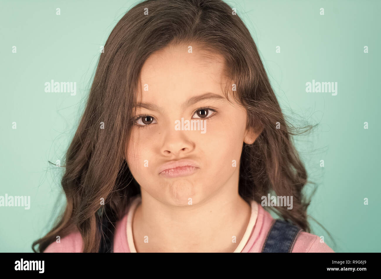 Beautiful girl looking sad with pouted lips. Cute kid with long hair ...