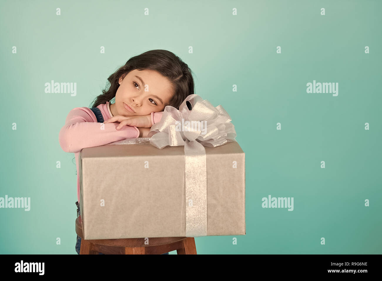 Box with ribbon bow and little girl. Box with present or gift Stock ...