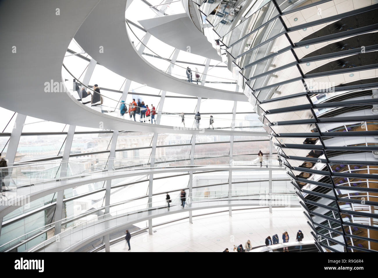 Visitors inside the glass dome on the top of Reichstag Building, a seat ...