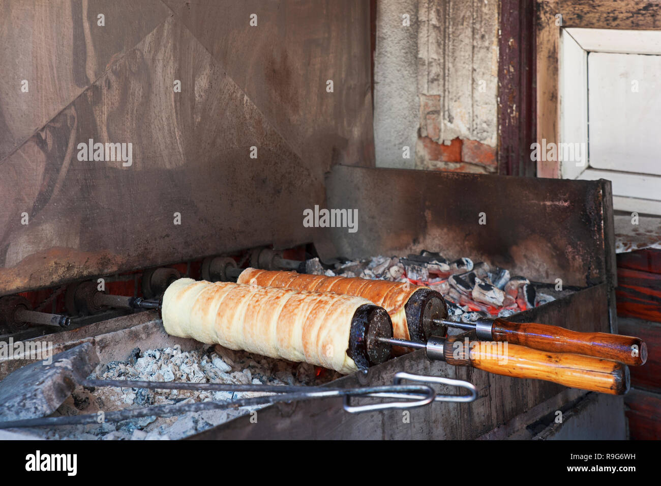 Kurtoskalacs, a spit cake traditional to Transylvania region, baking on ...