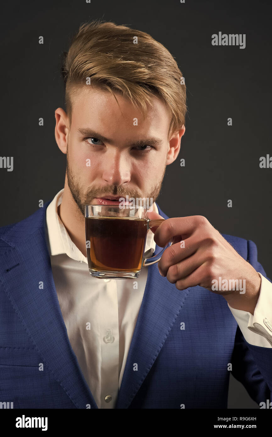Man businessman drink cup of tea in blue jacket, white shirt on grey ...