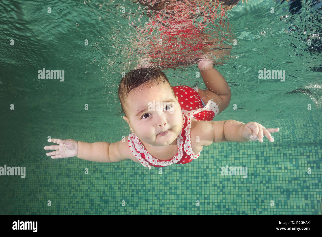 Little Baby Learning To Swim Underwater In A Swimming Pool High ...