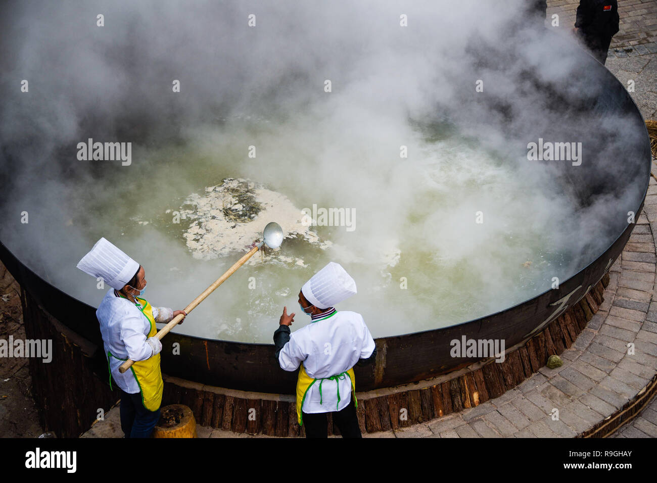 December 24, 2018 - Xingyi, China - Workers prepare a giant pot of ...