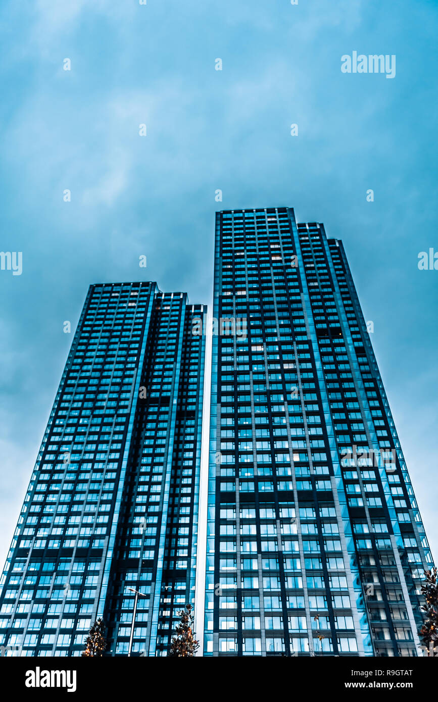 wide angle view to blue background of glass high rise building ...