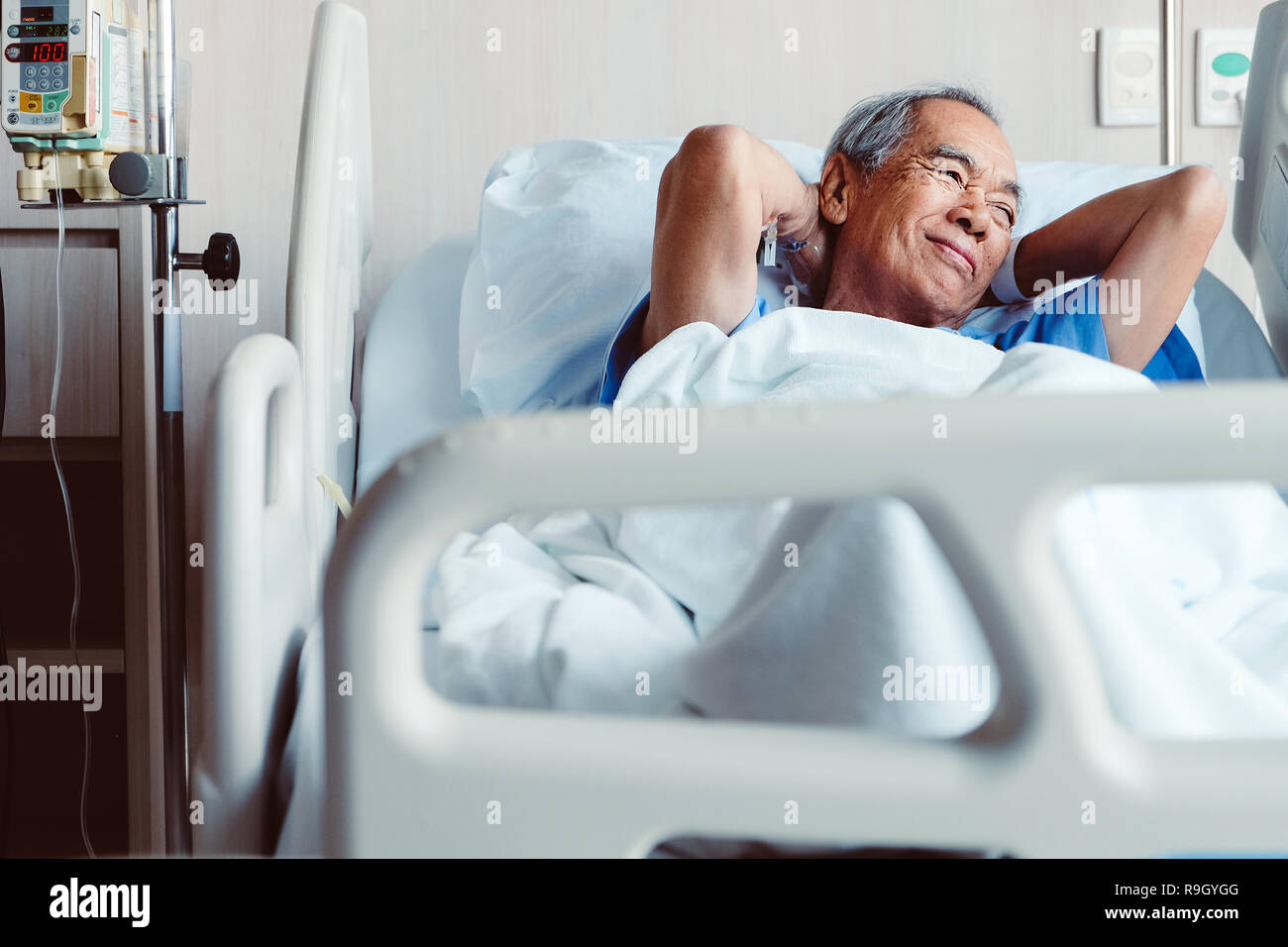 Elderly patients relax in hospital bed Stock Photo - Alamy