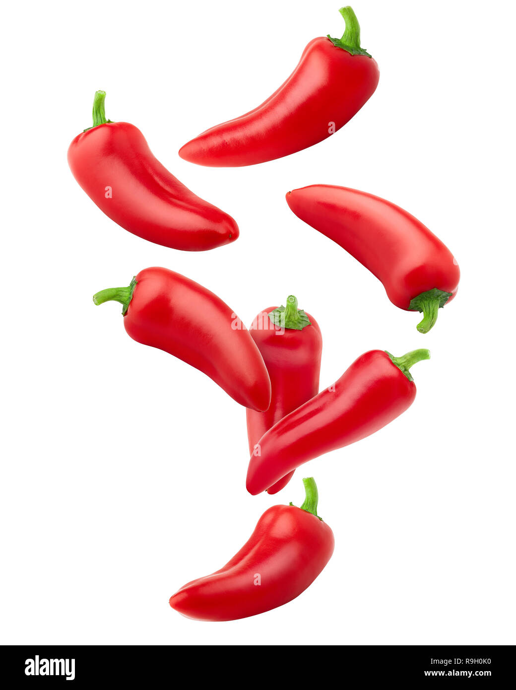 Falling red hot chilli peppers on white background, isolated, high ...