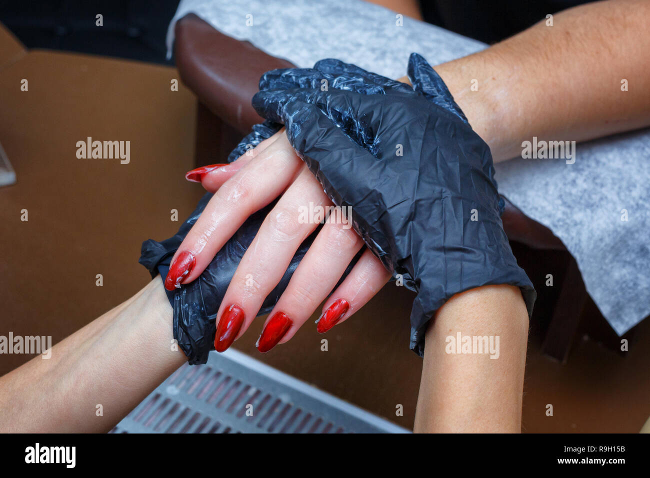 hand care salon manicure, master moisturizes the hands of the client ...