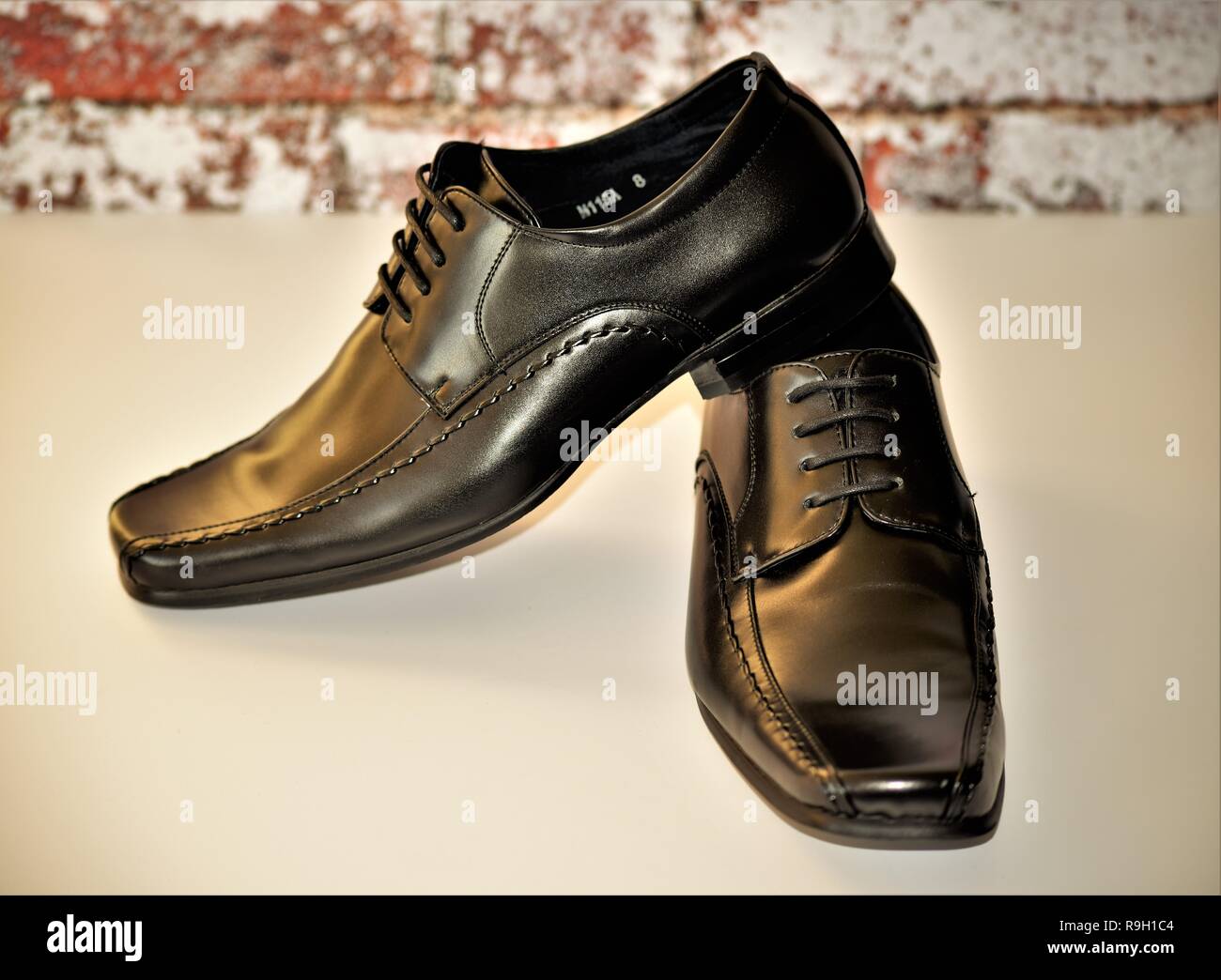 Square flat Toe elegant men shoes captured on white surface with a bit ...