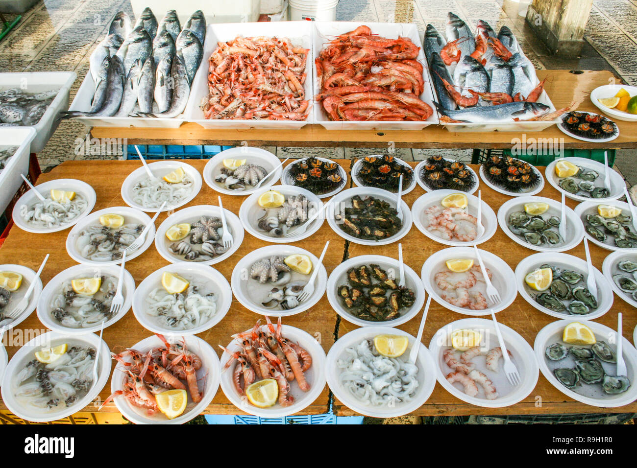 Open air street food fish market on Bari promenade with raw fresh sushi ...