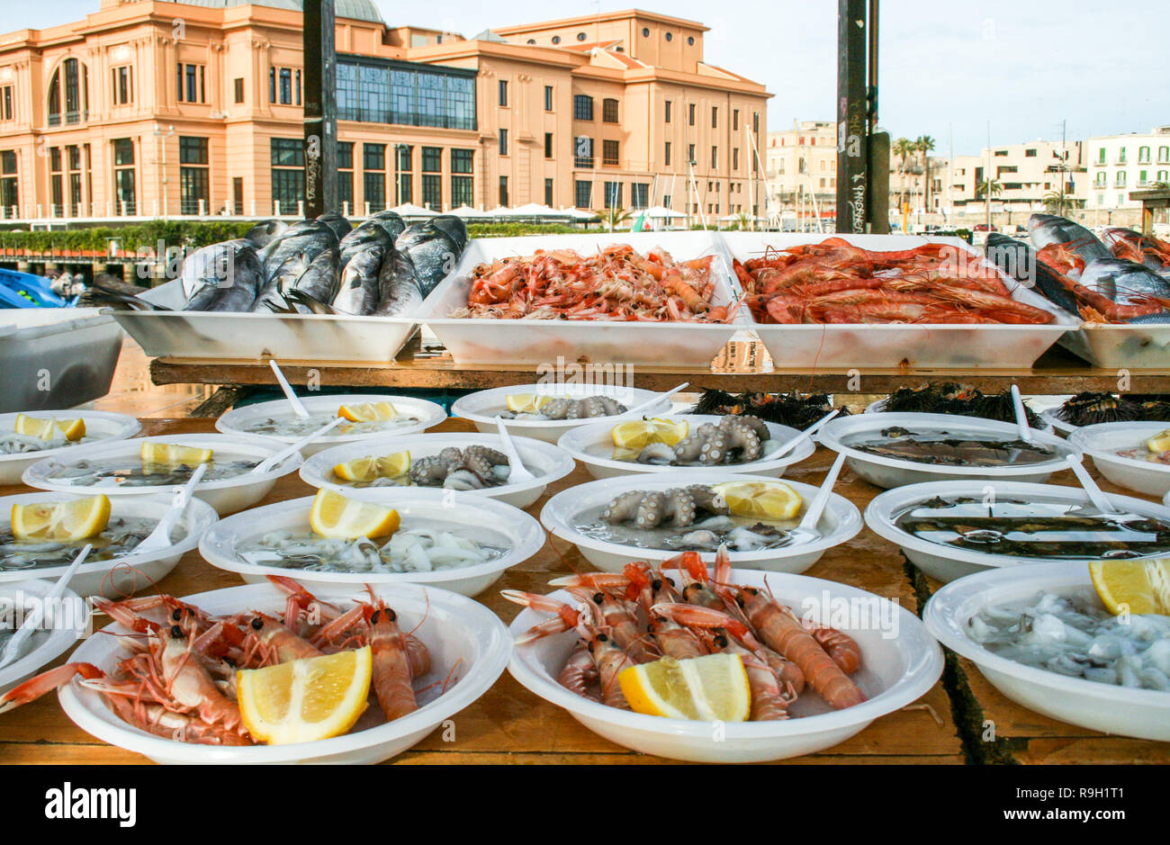 Open air street food fish market on Bari promenade with raw fresh sushi ...