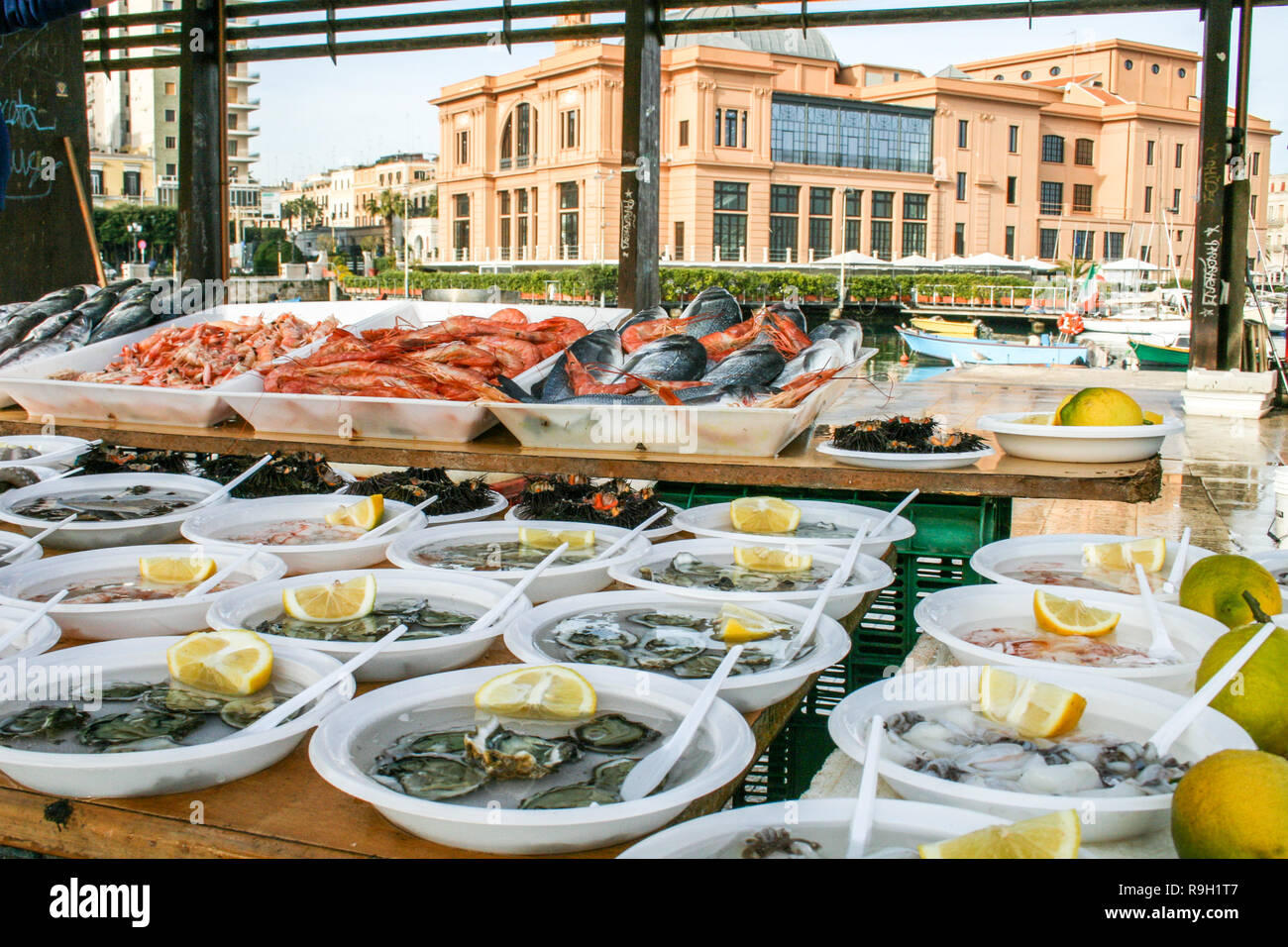 Open air street food fish market on Bari promenade with raw fresh sushi ...