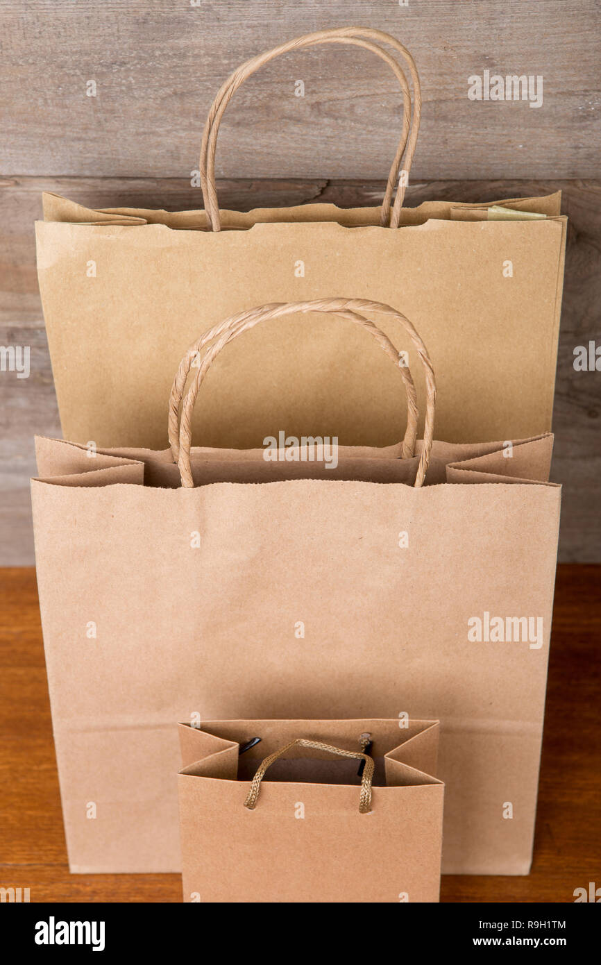 Cardboard shopping bags on wooden background Stock Photo - Alamy