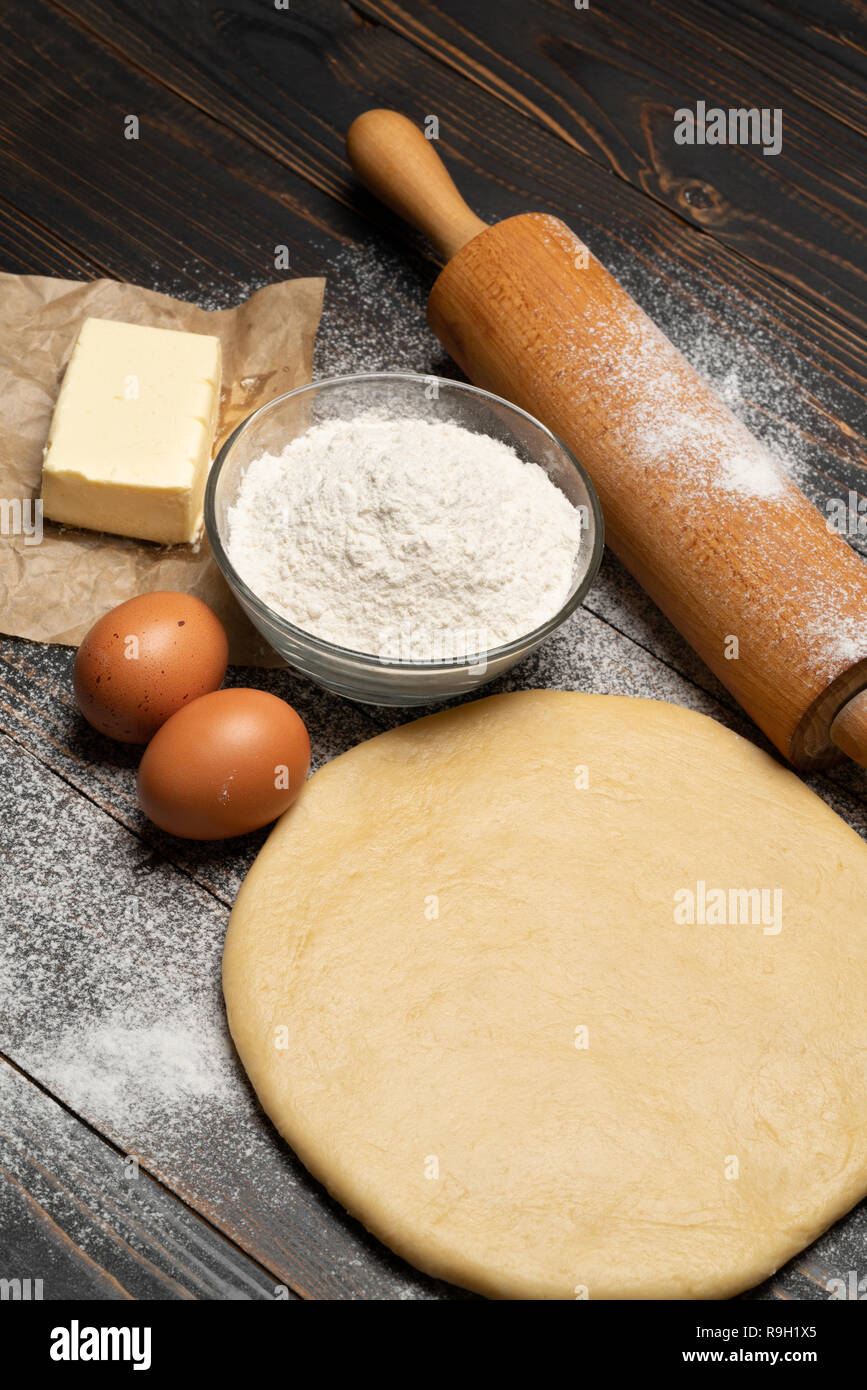 rolled and unbaked Shortcrust pastry dough recipe on wooden background ...