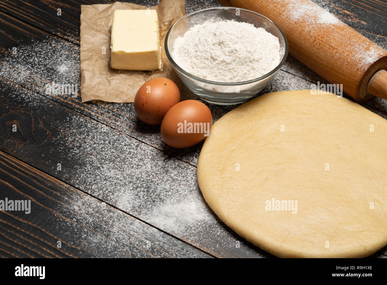 rolled and unbaked Shortcrust pastry dough recipe on wooden background ...