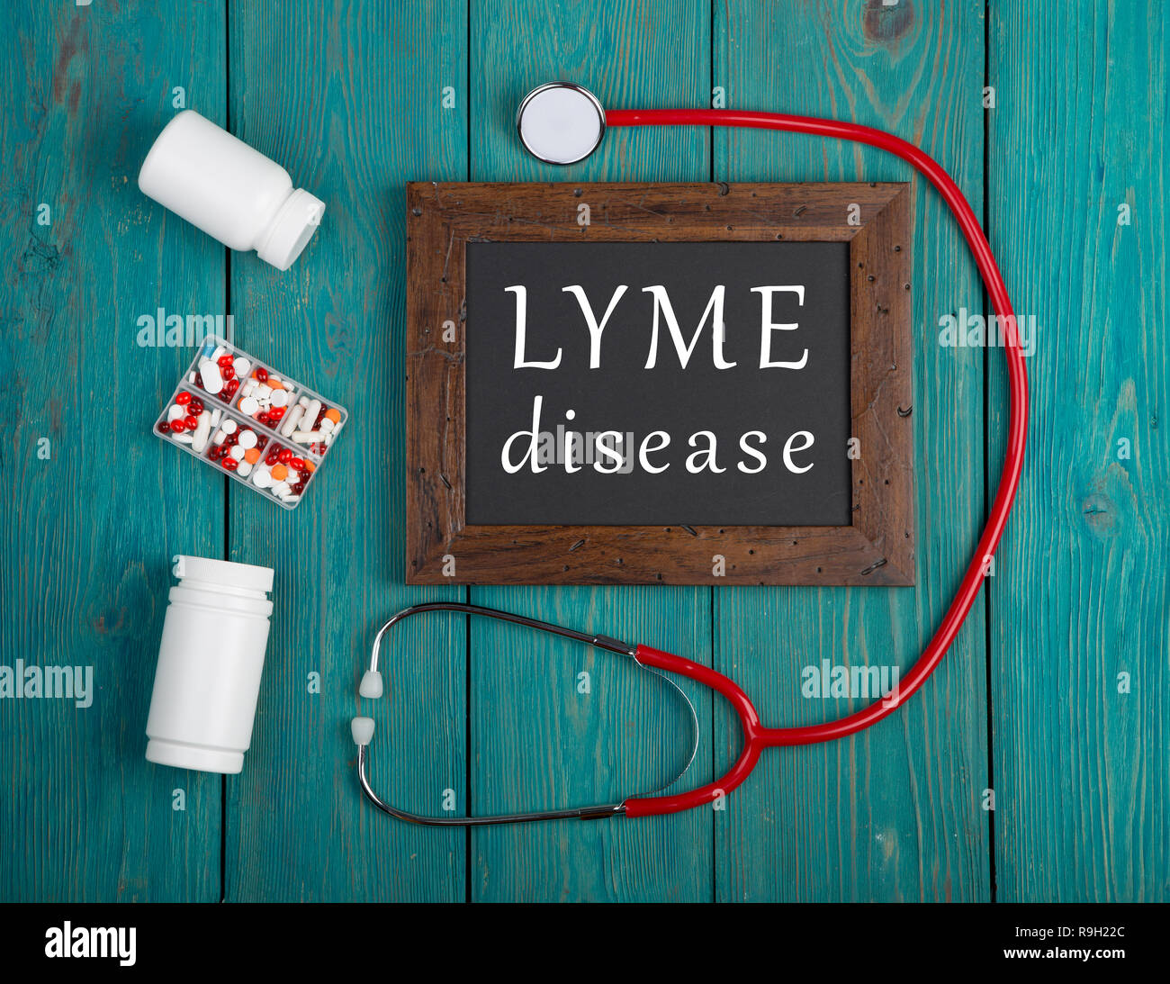 Medecine concept - Blackboard with text "Lyme disease", pills and ...
