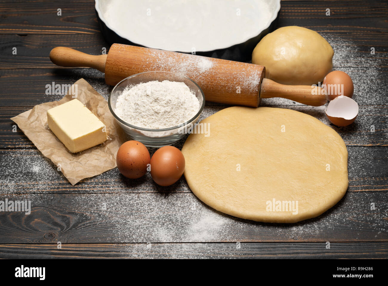 rolled and unbaked Shortcrust pastry dough recipe on wooden background ...