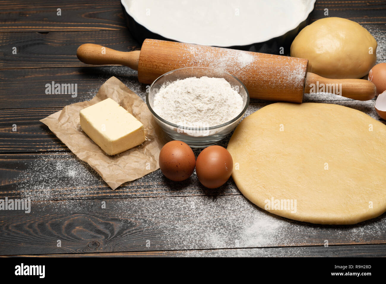 rolled and unbaked Shortcrust pastry dough recipe on wooden background ...