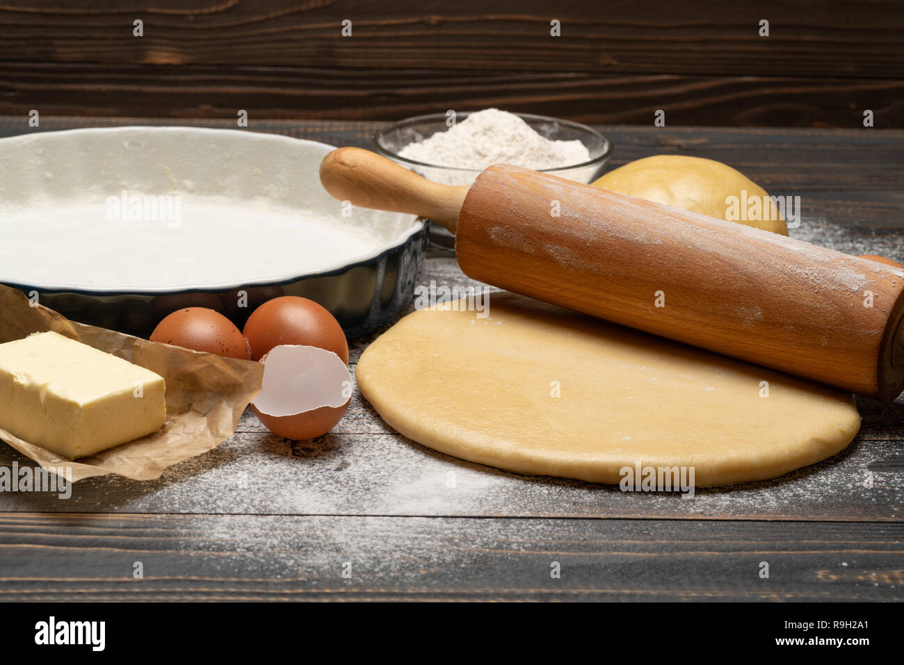 rolled and unbaked Shortcrust pastry dough recipe on wooden background ...