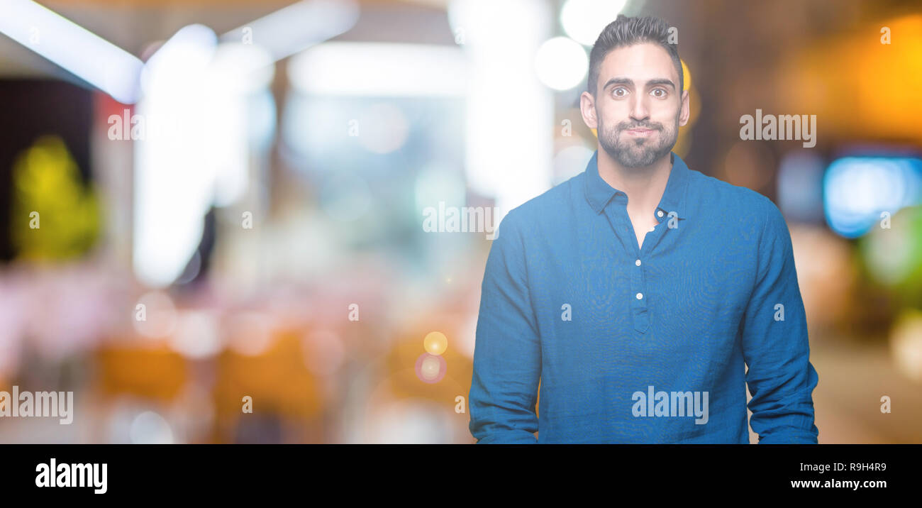 Young handsome man over isolated background puffing cheeks with funny ...