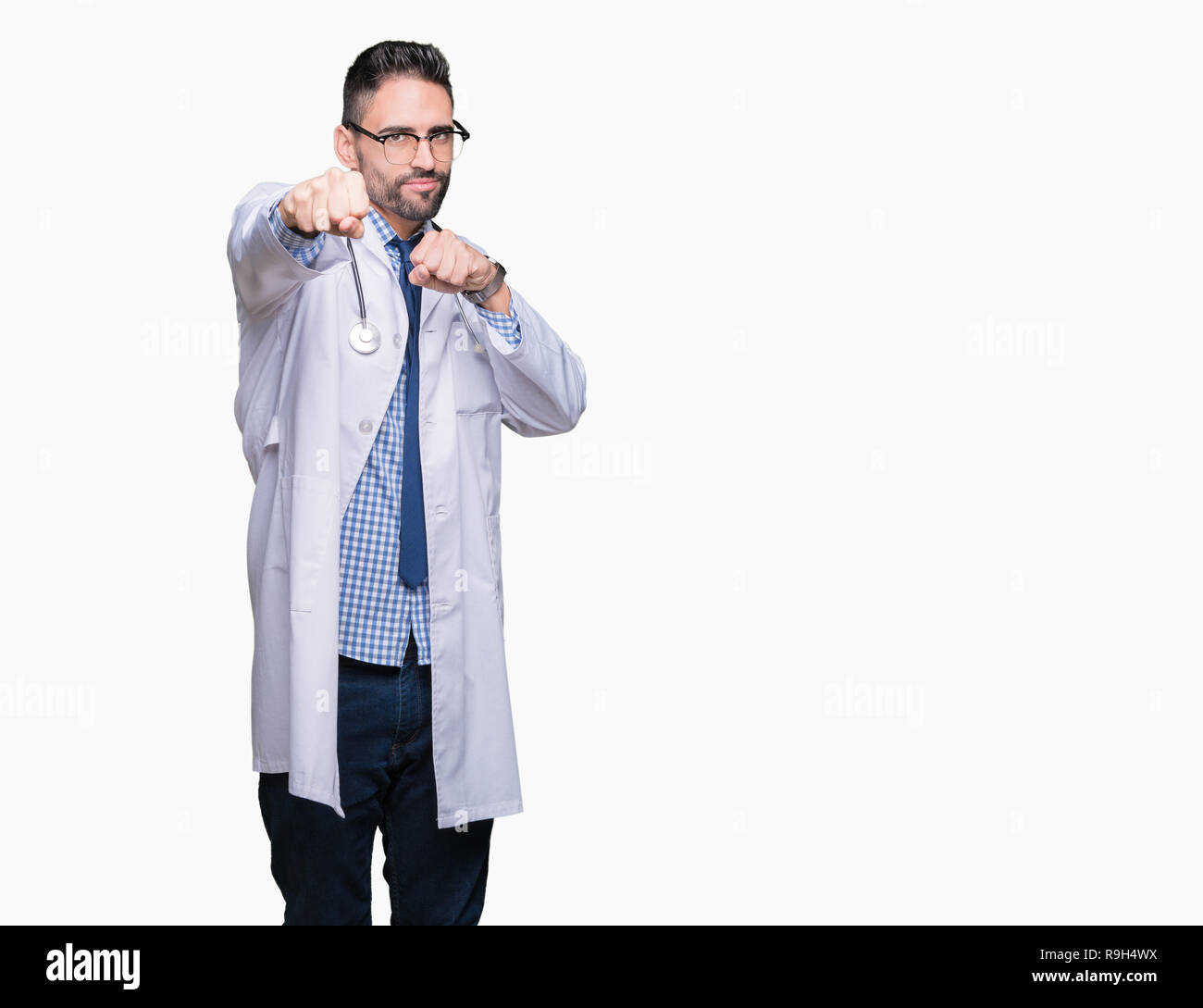 Handsome young doctor man over isolated background Punching fist to ...