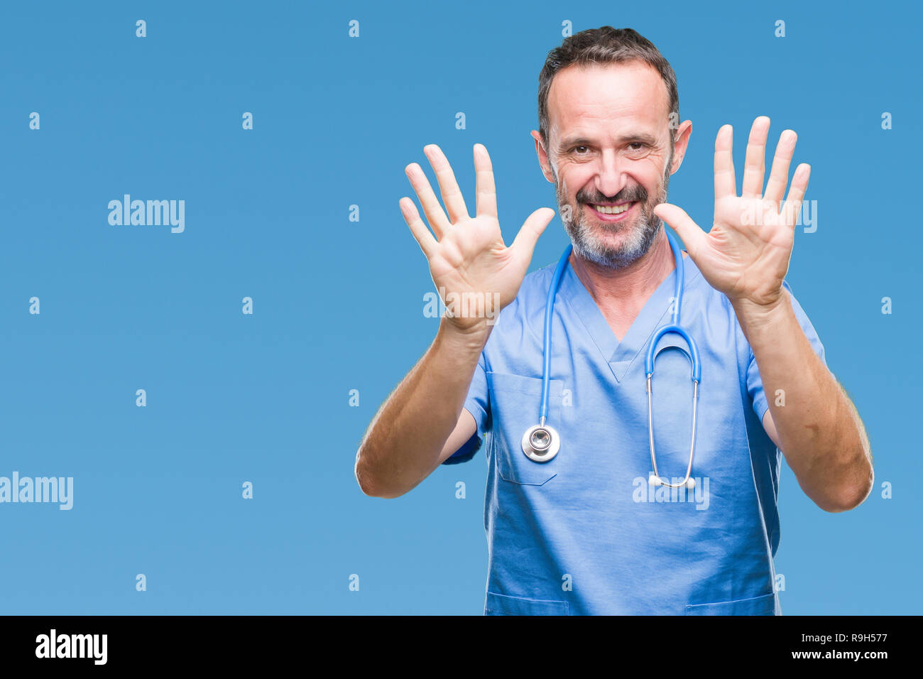 Middle age hoary senior doctor man wearing medical uniform over ...