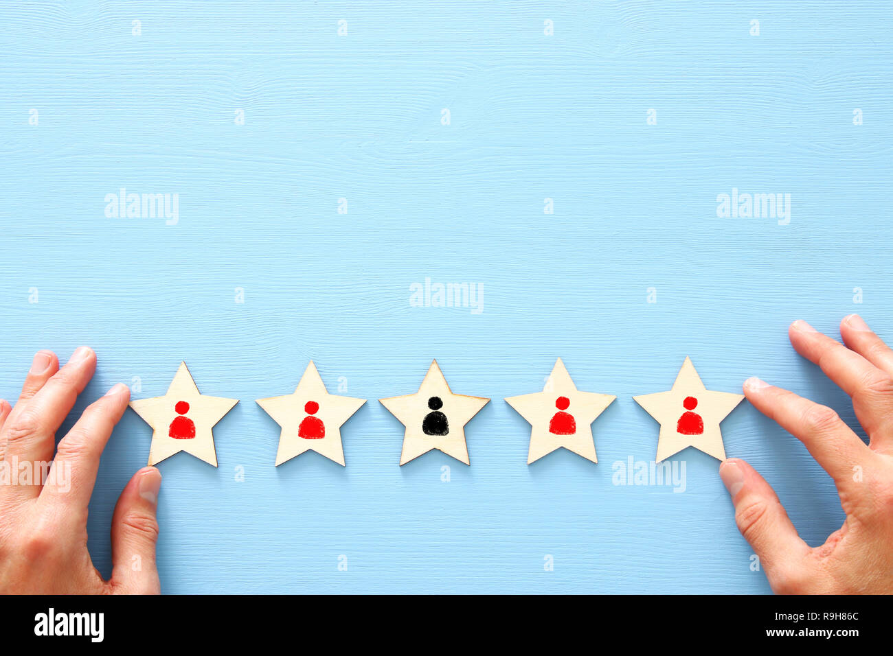 photo of 5 star symbols with people icons over wooden table ,human ...