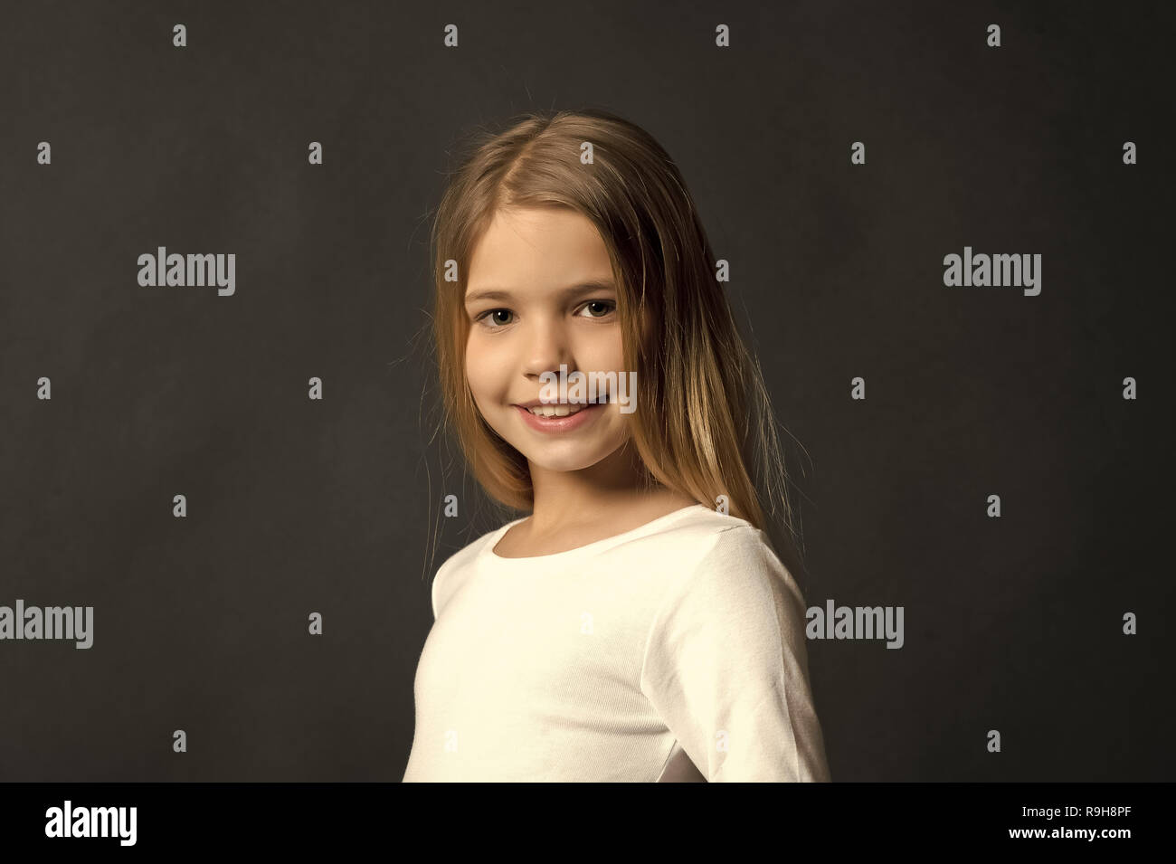 Kid model smiling with long healthy hair. Girl with smile on adorable ...