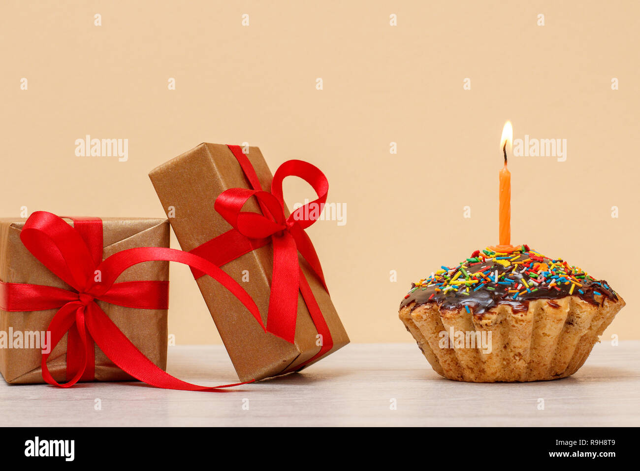 Tasty birthday muffin with chocolate glaze and caramel, decorated with ...
