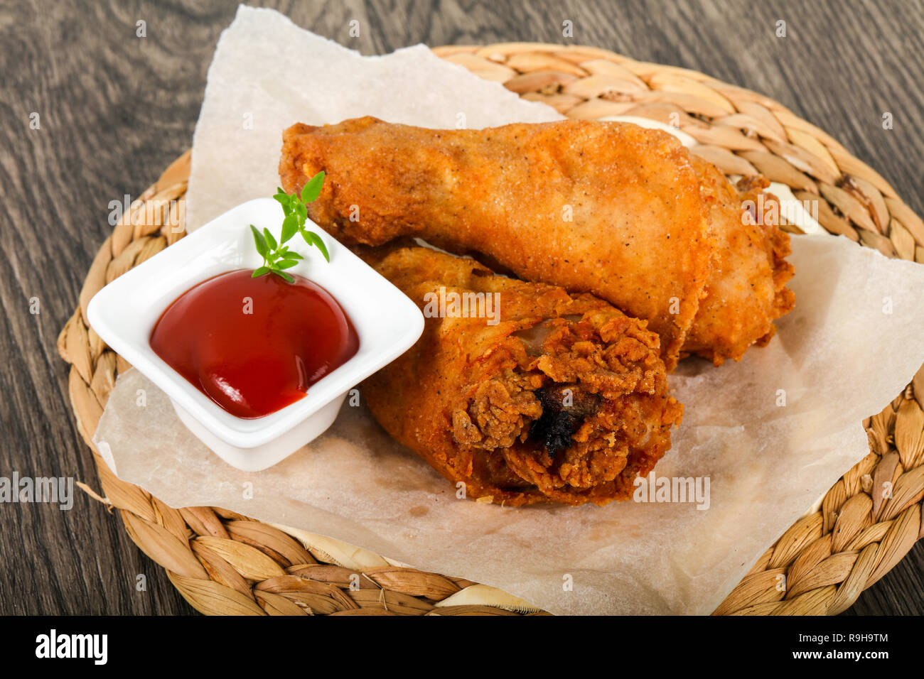Crispy chicken legs with ketchup Stock Photo - Alamy