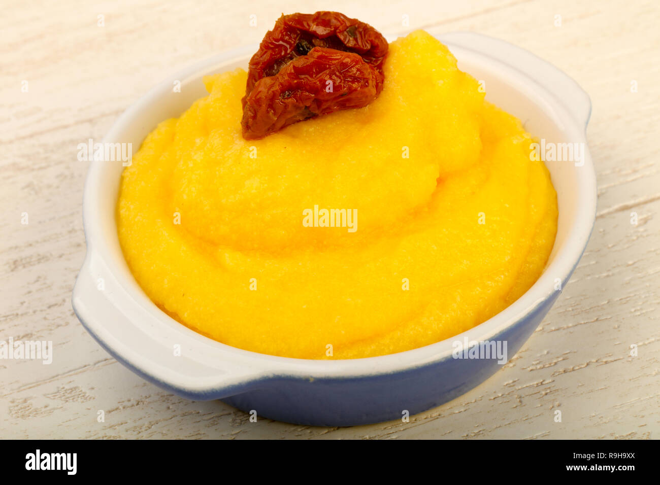 Polenta with dry tomato Stock Photo - Alamy