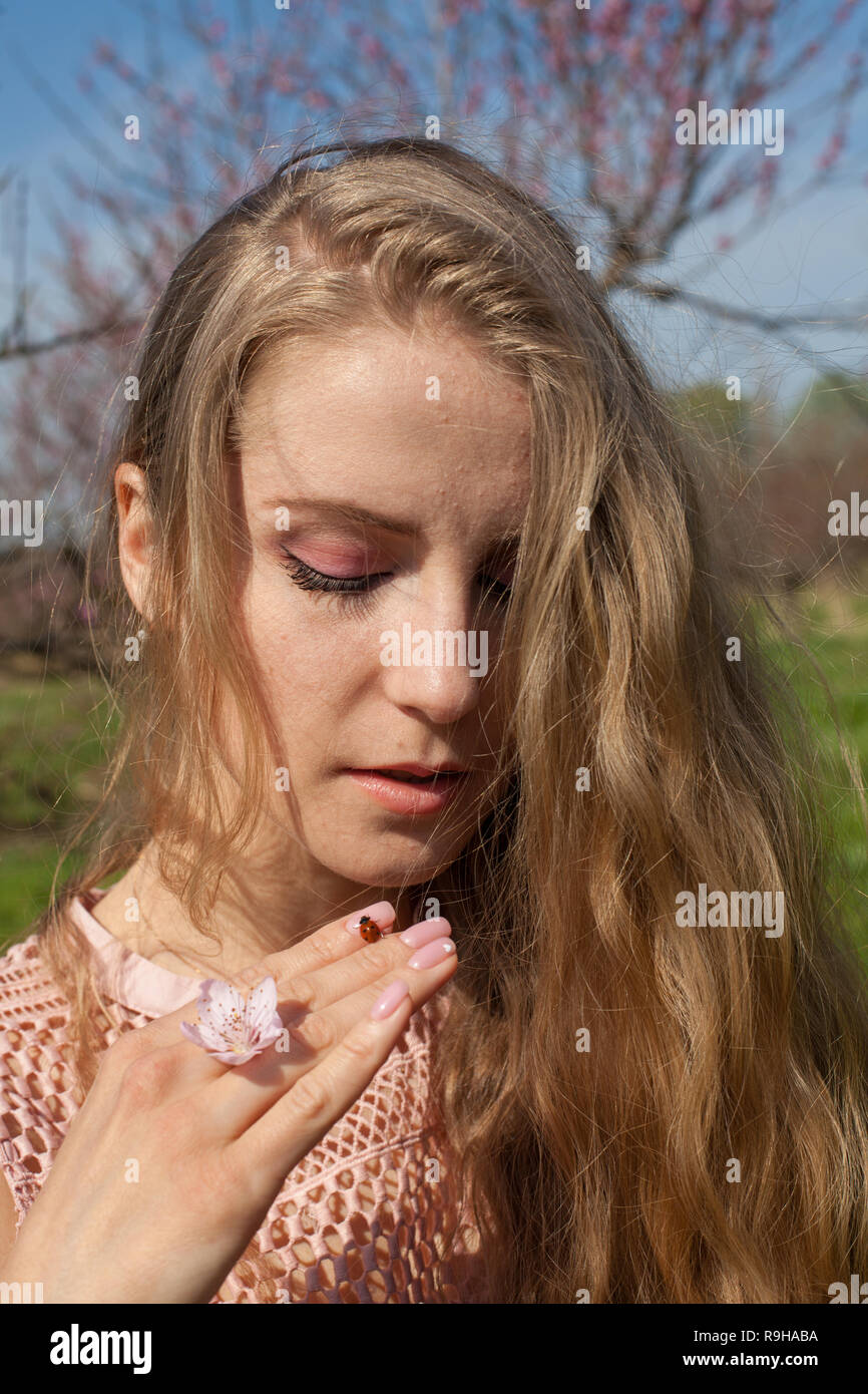 beautiful blonde woman portrait insect Ladybug nice Stock Photo - Alamy