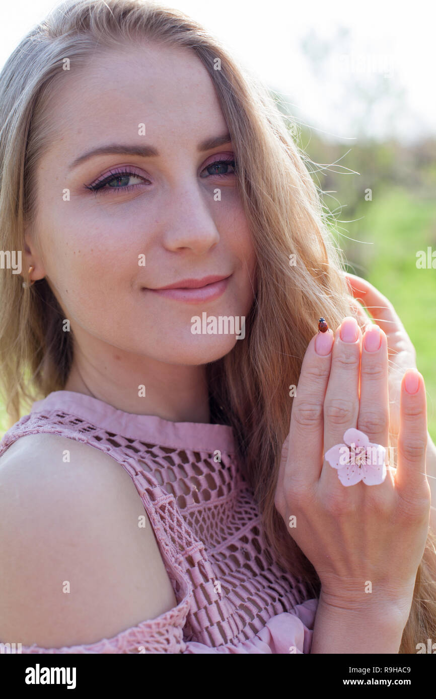 beautiful blonde woman portrait insect Ladybug nice Stock Photo - Alamy