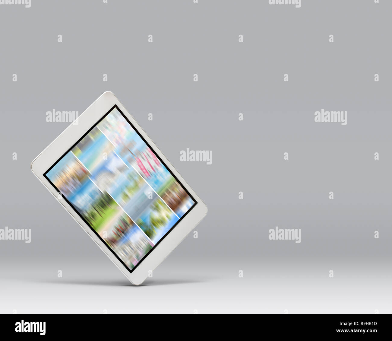 Digital tablet standing up with blurred images on the screen and copy ...