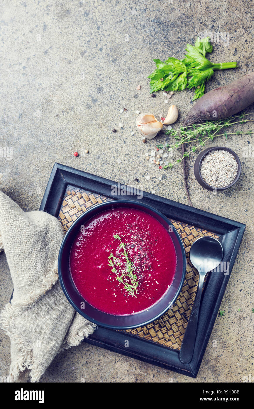Cold Beetroot mashed soup with cream, apple, cheese and thyme in a dark ...