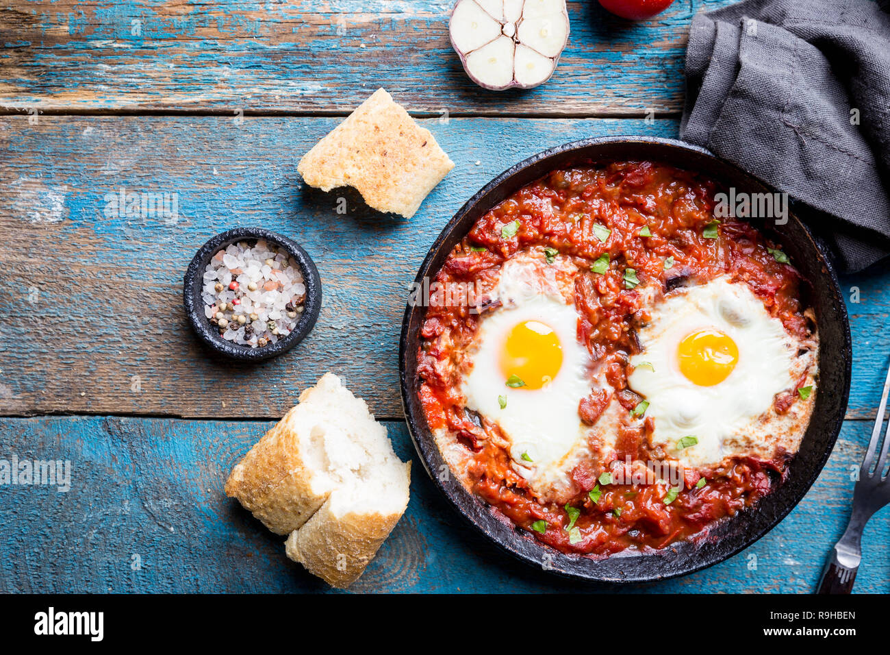 Shakshuka, Fried Eggs in Tomato Sauce in iron frying pan. Typical ...