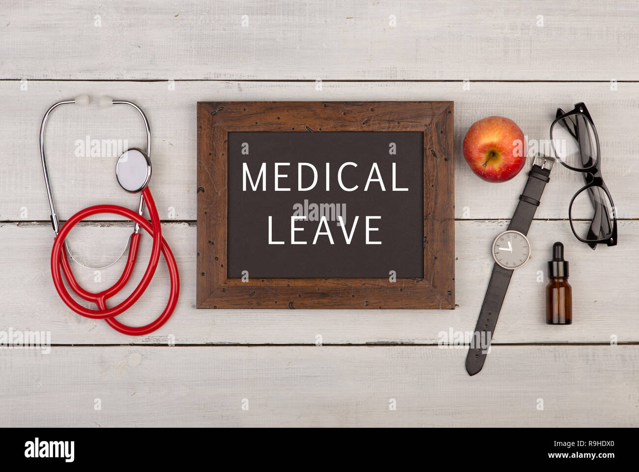 Medecine concept - blackboard with text "Medical leave", eyeglasses ...