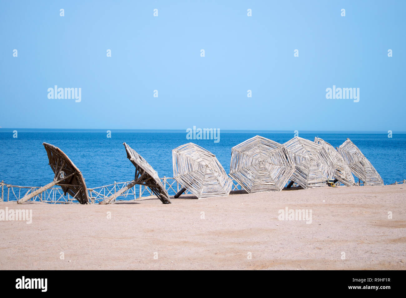 vacation in exotic countries. Wooden umbrellas lined up in the ...