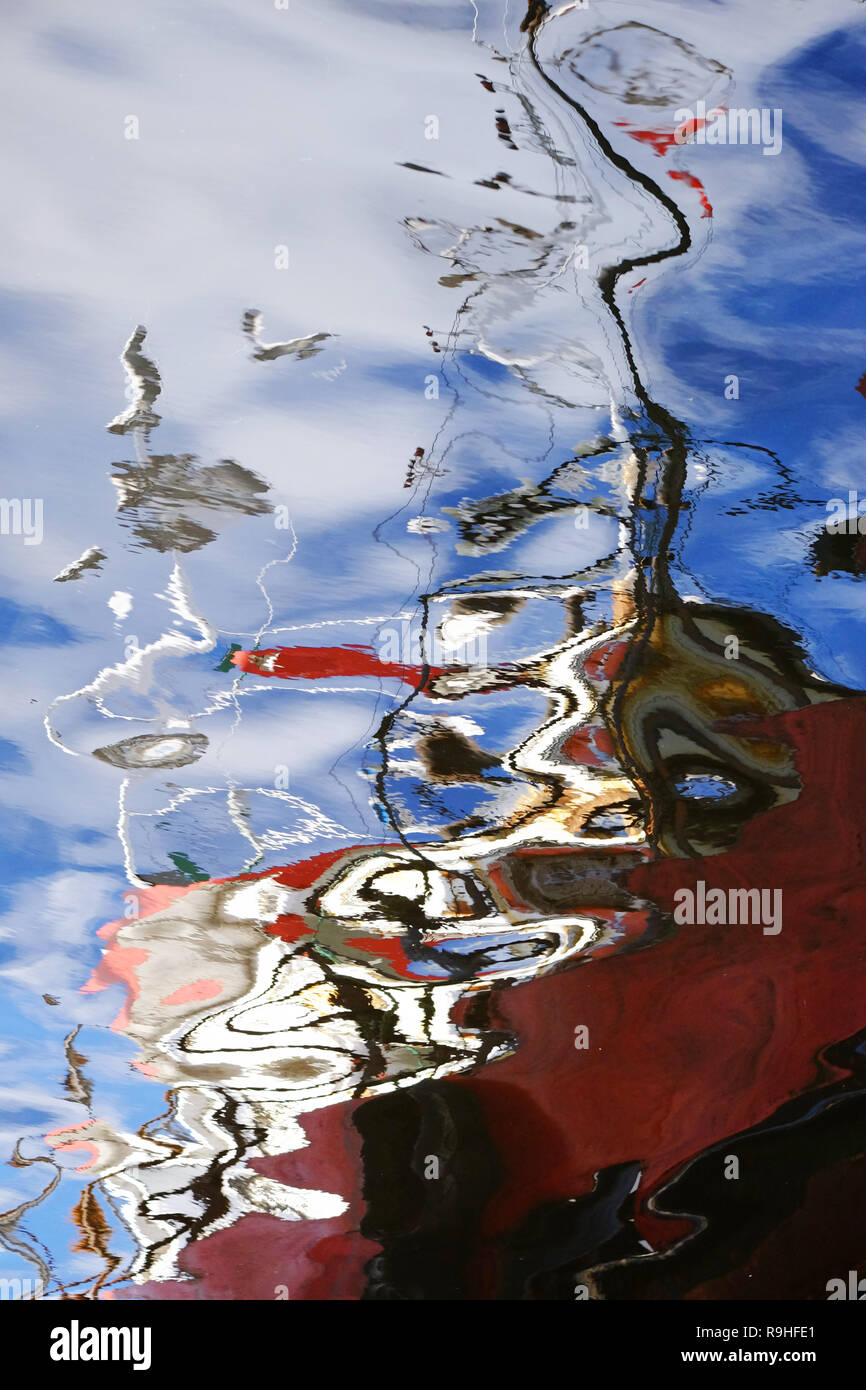Colorful water reflection of a fishing boat, abstraction, background ...